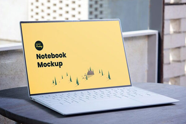 Mockup of a Notebook Device on a Wooden Table Free Download | Resource Boy