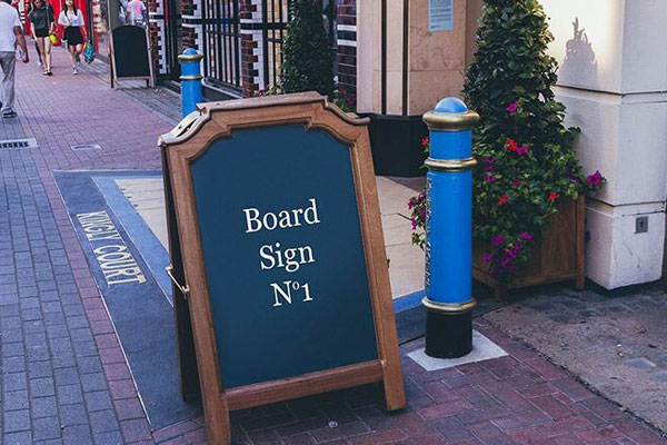 Mockup of a Stylish and Wooden Board Sign on the Street Free Download ...