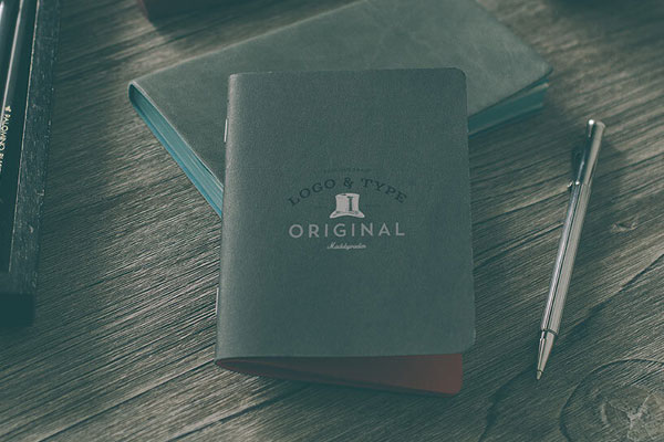 Mockup of a Notebook with Transparent Cover and a Pen (FREE) - Resource Boy