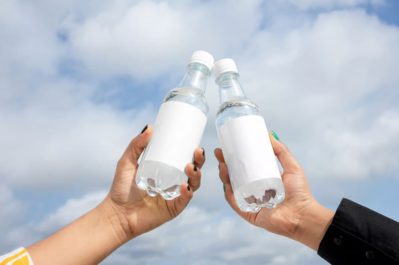 Two Bottle in Hand Mockups Free Download | Resource Boy